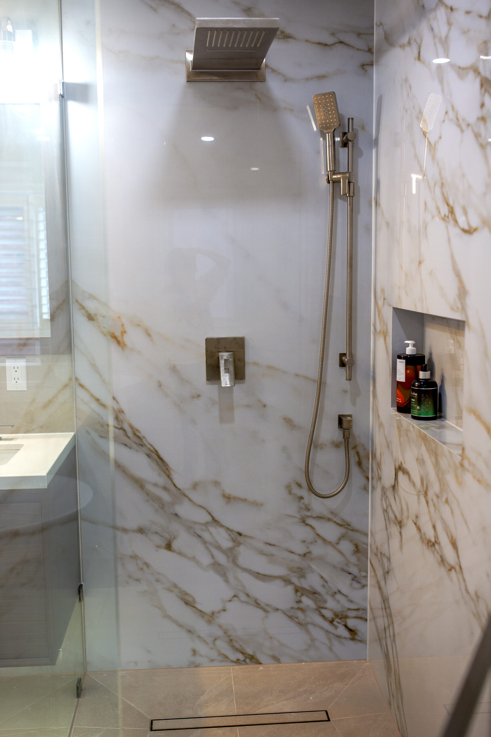 Luxury Bathroom Reno: Italian Slabs, Custom Vanity & Brass Finish